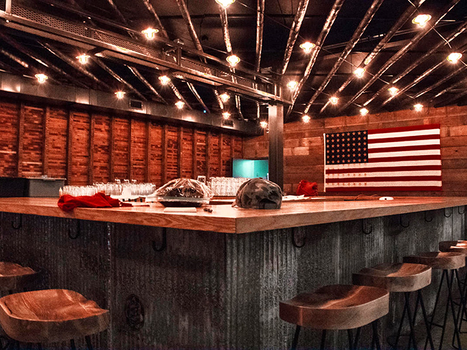 The bar isn't just serving drinks—it's serving possibilities. American flag backdrop says "patriotism tastes like good bourbon."