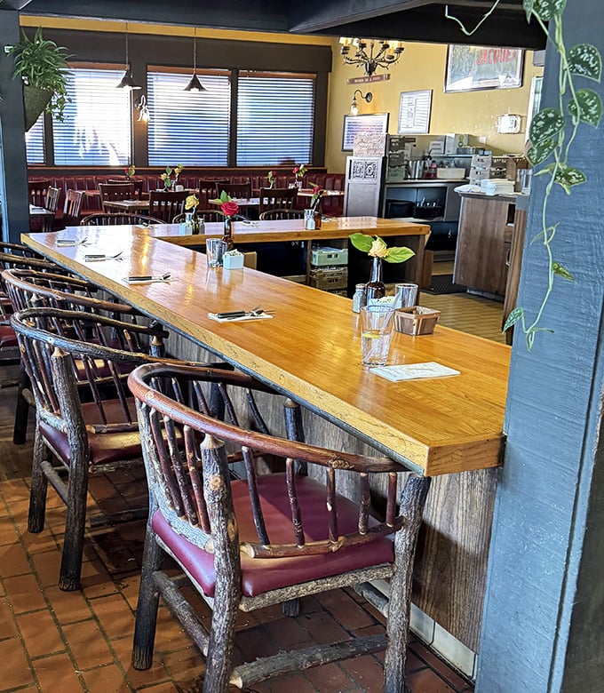 The counter seating—where solo diners become temporary neighbors and the best menu recommendations come from strangers who become friends.