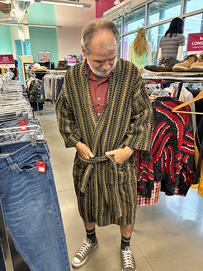Shopping becomes performance art as this gentleman discovers his inner royal in a vintage robe that screams "weekend luxury."