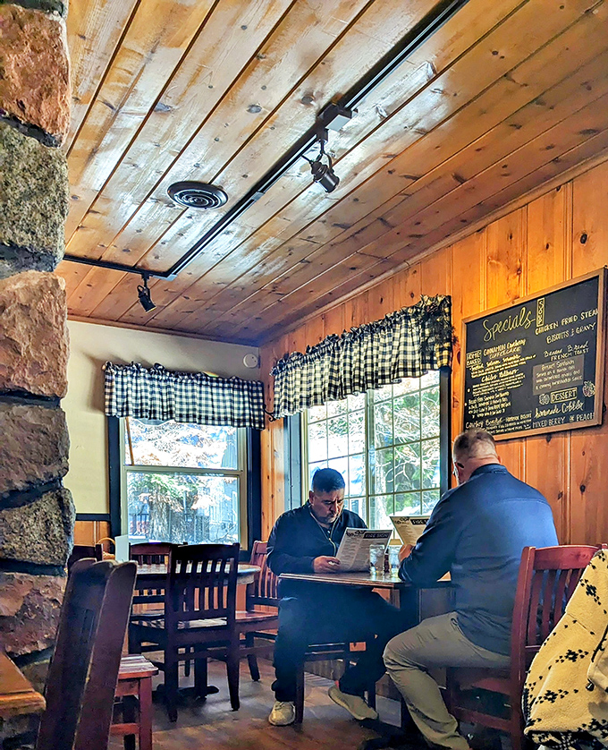 The checkered curtains and pine-paneled walls aren't just décor—they're a time machine to when breakfast conversations weren't interrupted by notification pings.