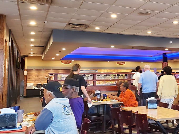 Where food dreams come true – diners enjoying the fruits of their buffet strategy while servers ensure no plate stays empty for long.