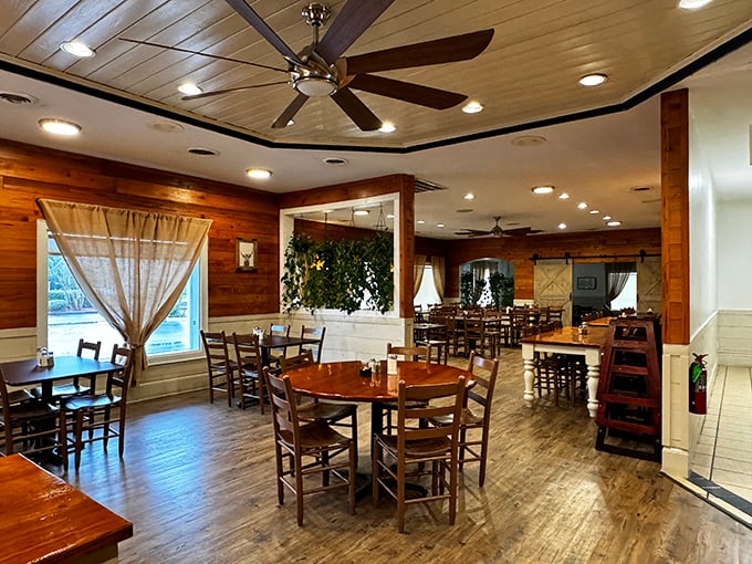 Wooden tables bathed in natural light, ceiling fans spinning lazily overhead – a dining room that invites you to stay awhile.