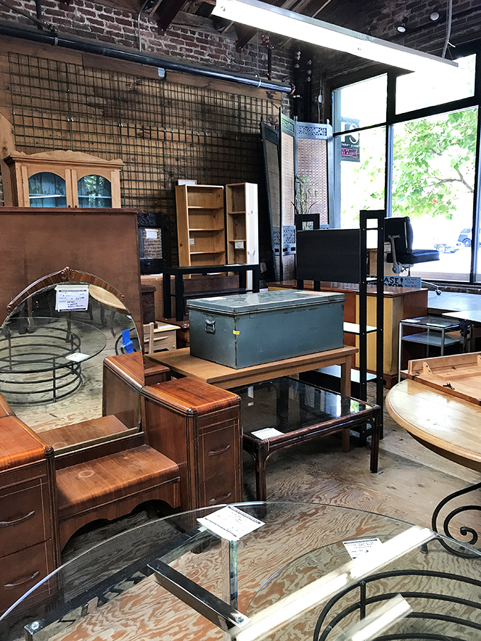 Furniture tetris at its finest—vintage vanities and practical tables arranged in a home decorator's dream obstacle course.