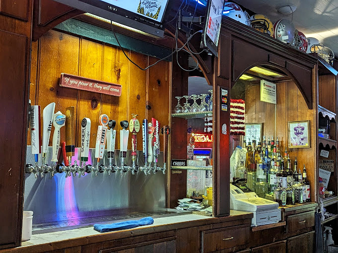 A bar setup that says, "We're not trying to reinvent drinking, we're just trying to do it right"—complete with the welcoming sign that beer is meant to bring joy.