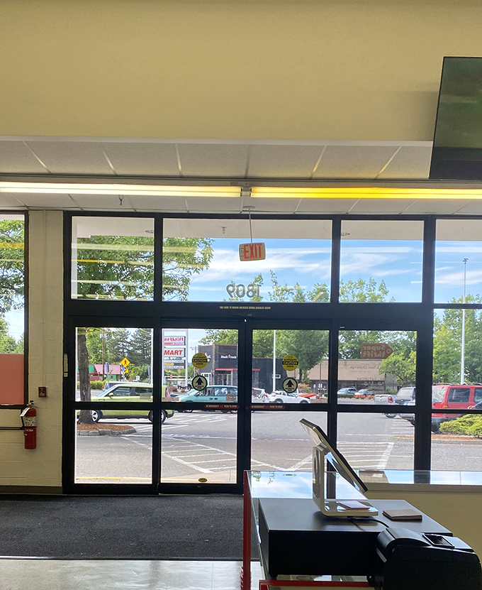 The exit sign—a gentle reminder that real life exists outside this bargain wonderland.
