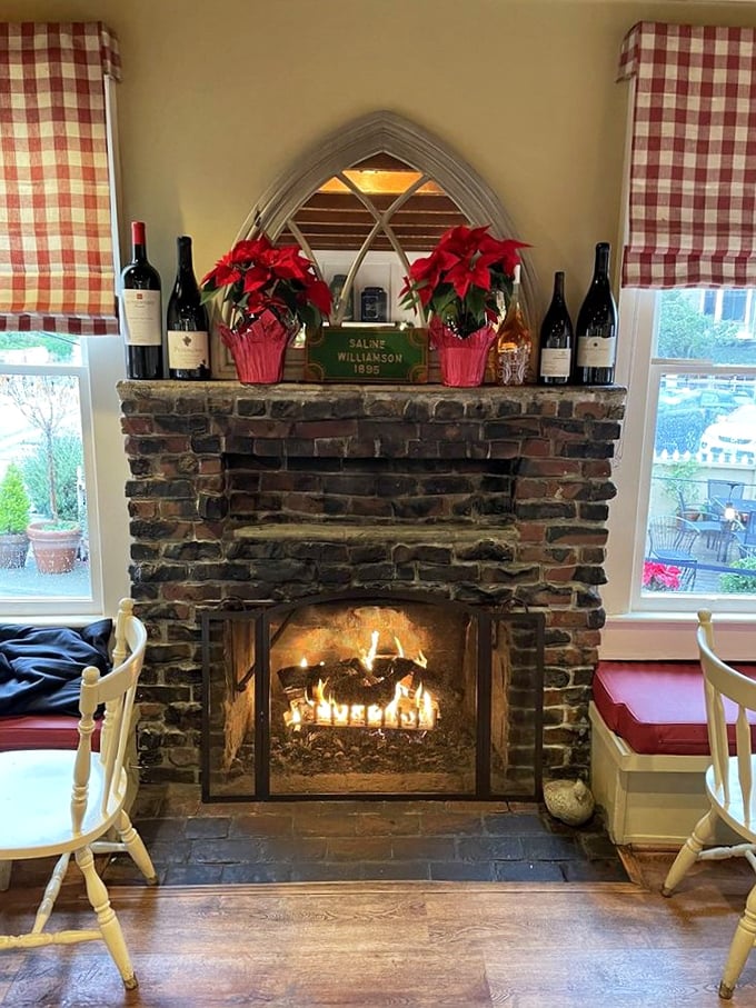 Nothing says "stay awhile" like a stone fireplace adorned with poinsettias and wine bottles—the heart of this converted home.