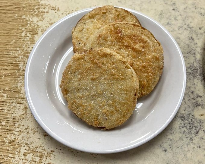Golden discs of fried green tomatoes—Southern currency in food form. Crispy, tangy perfection that makes you understand why they wrote a movie about them.