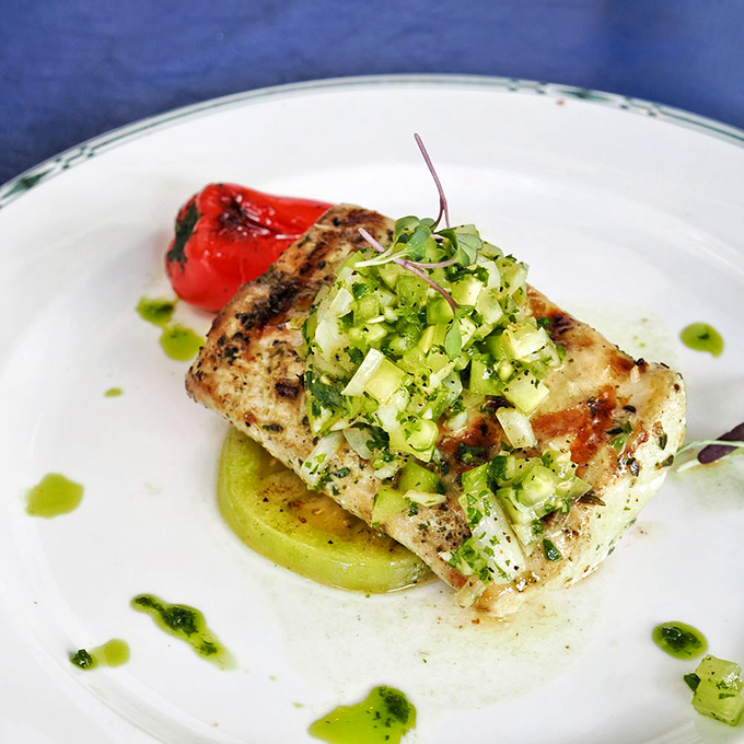 Grilled mahi topped with fresh cucumber relish—proof that sometimes the simplest preparations let truly great seafood shine brightest.