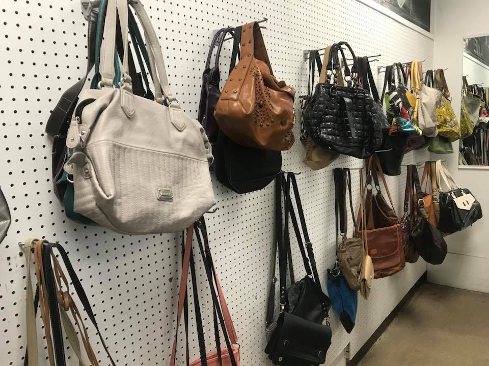 Handbag heaven on pegboard paradise—leather treasures waiting to be rediscovered and given second acts as fashion statements.