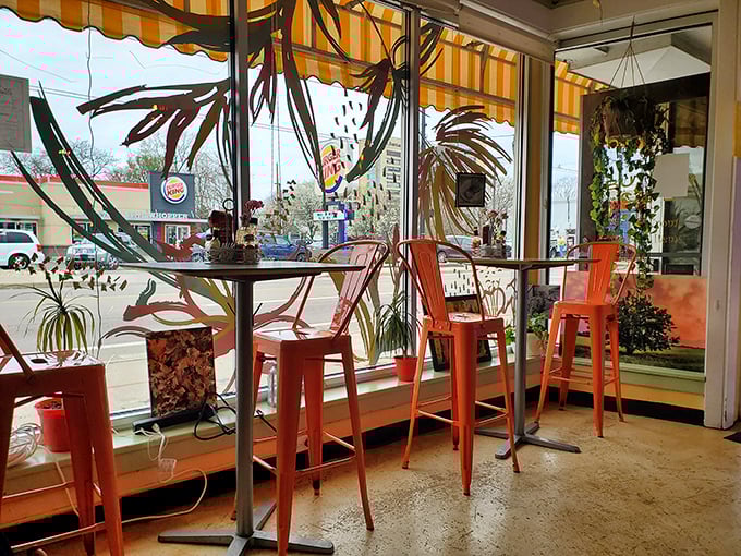 Those bright orange chairs by the window aren't just seating—they're front-row tickets to the best breakfast theater in town.