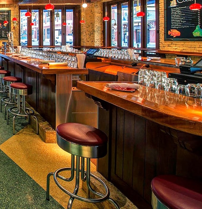 Red pendant lights cast a warm glow over the polished bar – the kind of place where everybody doesn't know your name, but soon will.