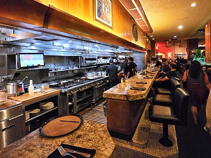 The open kitchen isn't just for show—it's dinner and a performance where chefs orchestrate culinary magic with the precision of seasoned conductors.