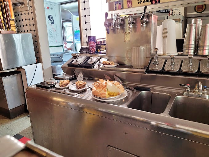 Where the magic happens—gleaming stainless steel, homemade pies on display, and equipment that's been turning out classics longer than most restaurants stay open.