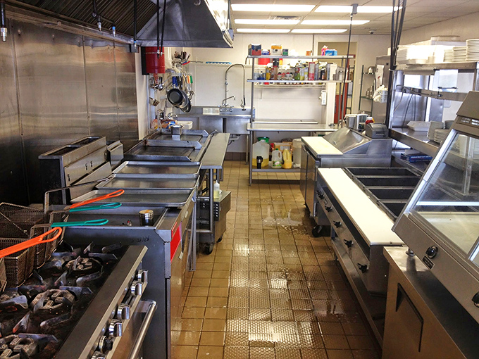 The engine room of breakfast magic—a kitchen where spatulas fly and griddles sizzle in the choreographed dance of diner perfection.