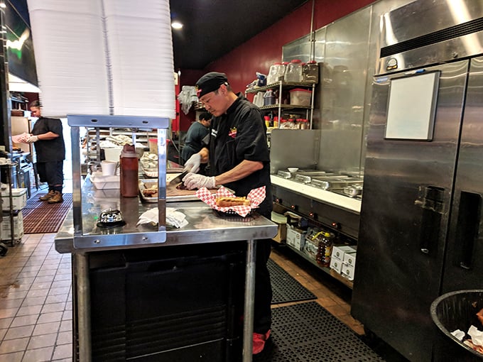 Where the magic happens—skilled hands transforming simple ingredients into smoky masterpieces. This kitchen knows that patience is the secret ingredient in great BBQ.
