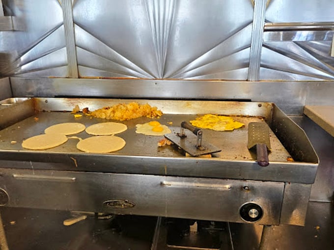 The griddle—hallowed ground where pancake batter transforms into golden discs of joy. A breakfast ballet performed daily.