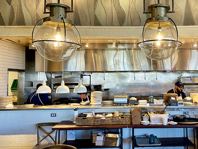 An open kitchen where culinary magic happens under globe lights – dinner and a show without the ticket price.