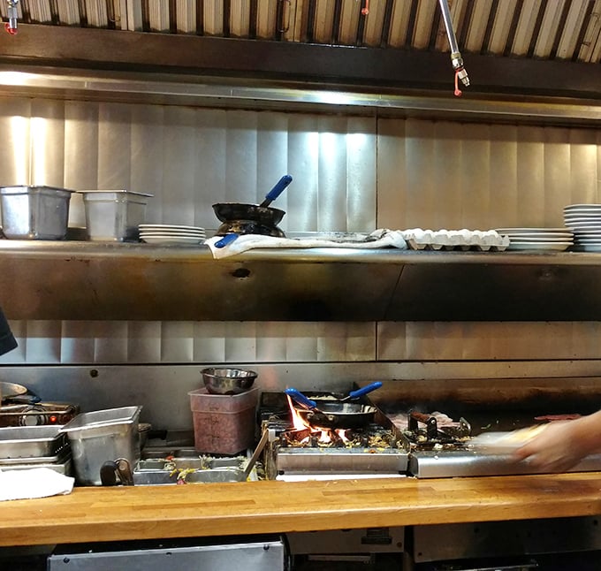 The kitchen pass—where breakfast alchemy happens. That flat-top grill has probably seen more action than the entire Marvel universe combined.
