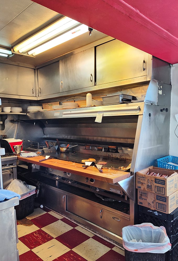 The kitchen pass—where breakfast dreams are born on a well-seasoned griddle that's seen more action than most Broadway stages.