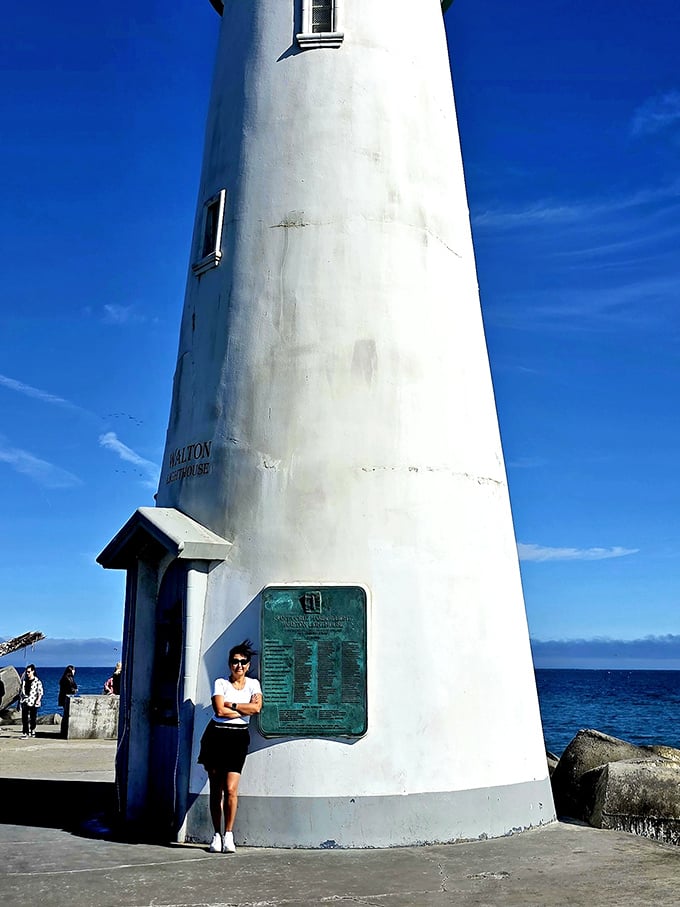 The lighthouse makes everyone look like they're posing for an album cover. That "I discovered something wonderful" smile is the universal souvenir.