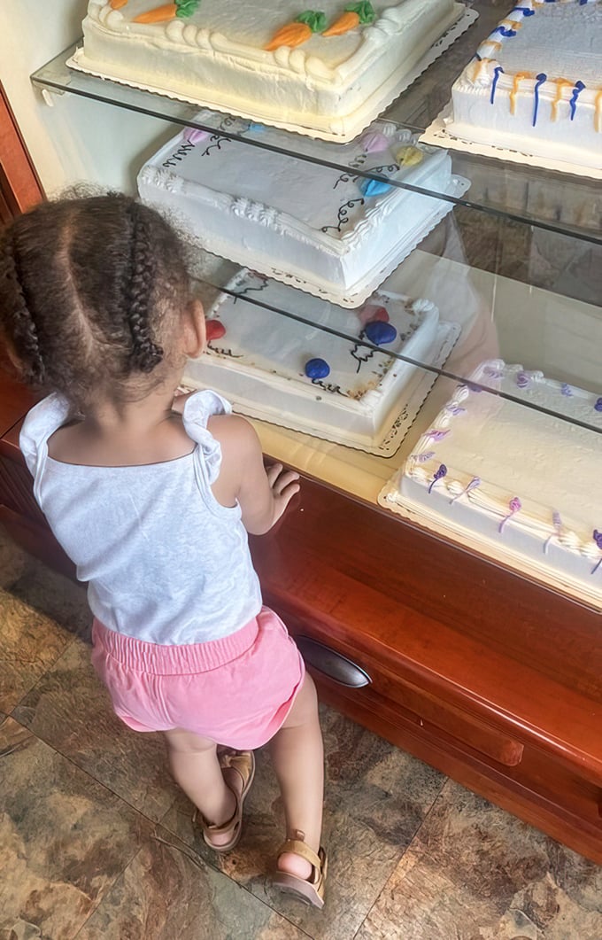 The magic of bakery cases through a child's eyes – where future sweet memories are being formed one cake at a time.