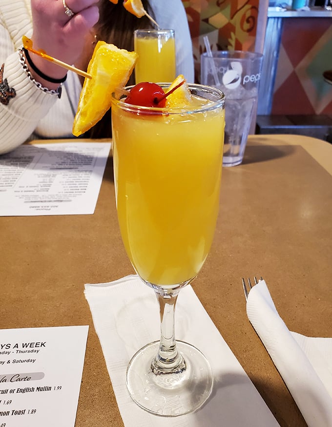 A mimosa garnished with pineapple and cherry—because sometimes breakfast calls for a little celebration. Monday morning meetings never stood a chance.