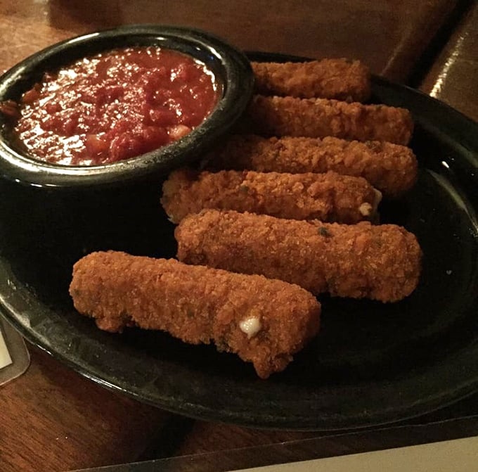 Mozzarella sticks with attitude—crispy soldiers standing at attention beside a pool of marinara for the perfect cheese pull moment.