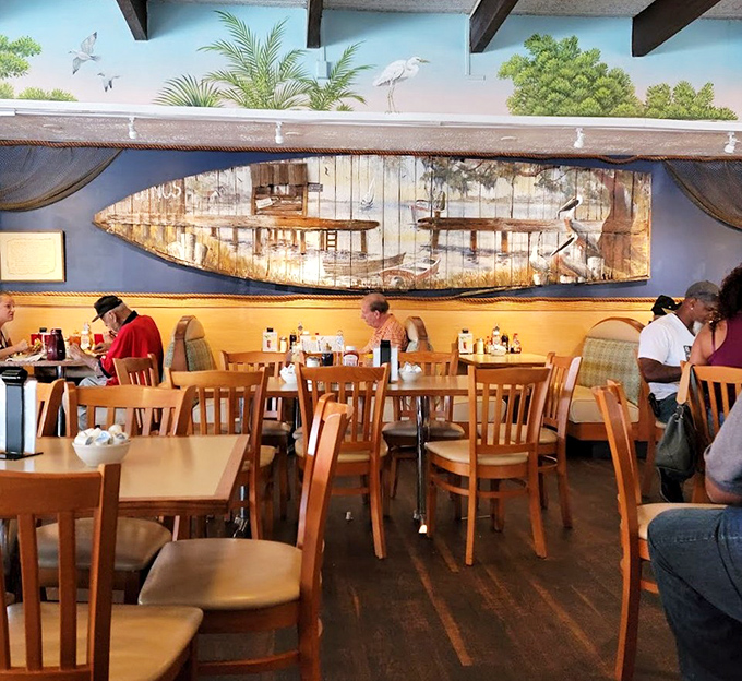 Coastal charm meets breakfast comfort with that boat-inspired wall art. A dining room that says "relax, you're on vacation time now."