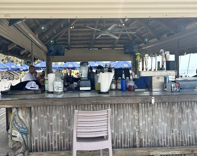 The tiki bar where vacation dreams come true. That "We ♥ Tips!" sign isn't subtle, but neither is the ocean view behind it.