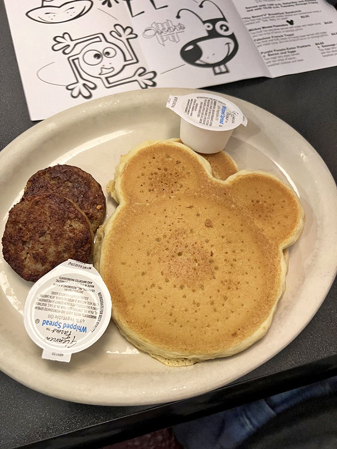 Mickey has nothing on this pancake. Golden-brown, perfectly round, and waiting for its maple syrup bath—childhood joy on a plate. 