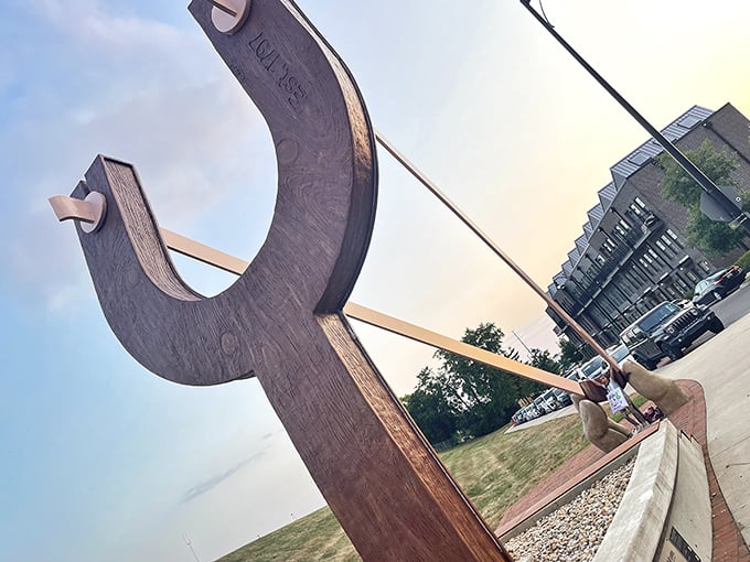 The tension in the band creates a perfect metaphor for anticipation, drawing visitors into the playful narrative of this unique sculpture.