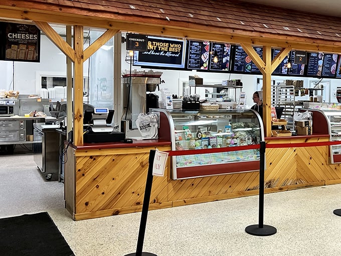 Behind this wooden counter, culinary magic happens daily, with display cases showcasing treasures more valuable than gold to pastry lovers.