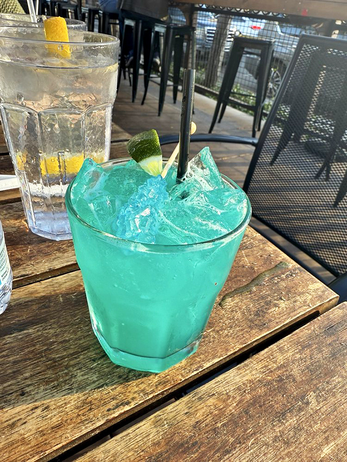 Electric blue cocktail that looks like it could power a small city. Refreshment with a side of vacation vibes, even on a Tuesday.