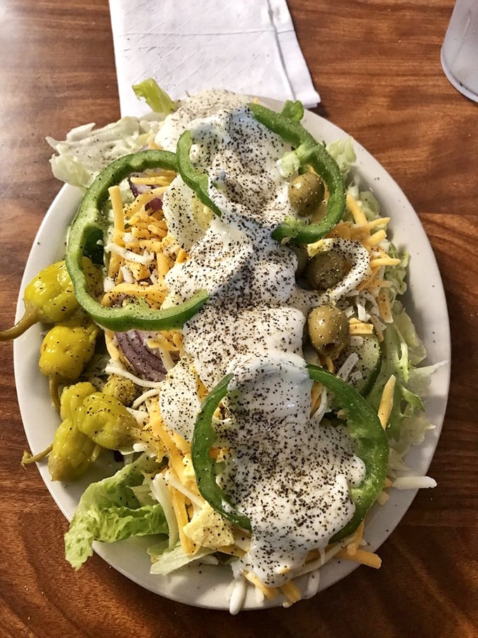 Even the salad gets respect here, proving that vegetables deserve proper treatment alongside their seafood cousins.
