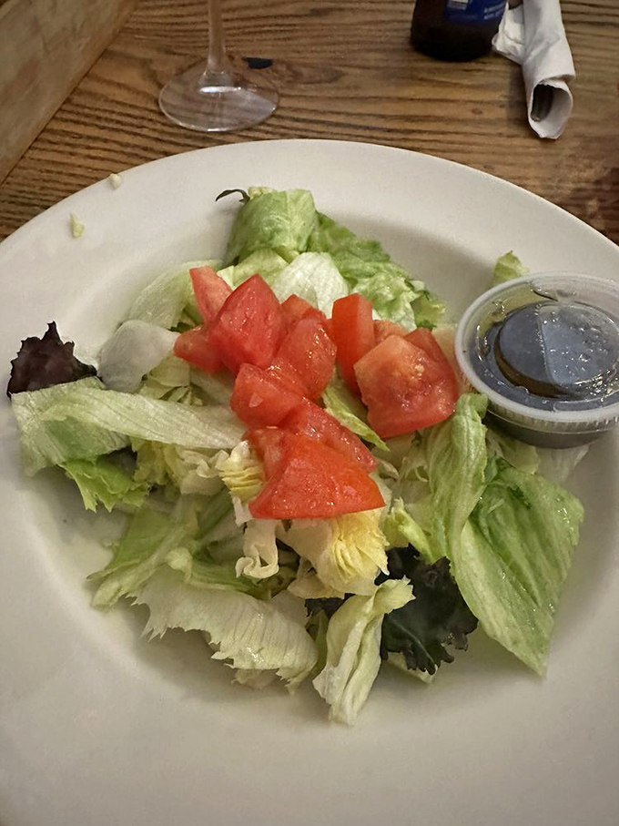 Even the humble side salad gets respect here—crisp greens, ripe tomatoes, and house-made dressing that puts bottled versions to shame.