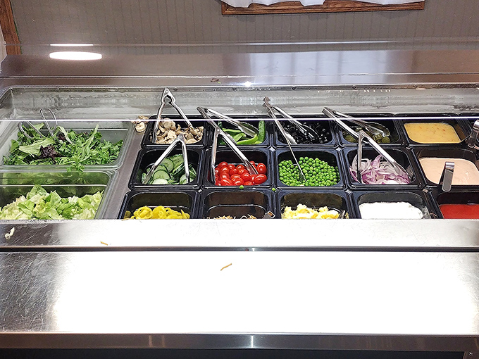 A salad bar that actually deserves respect—fresh ingredients waiting to complement your meal rather than apologize for it.