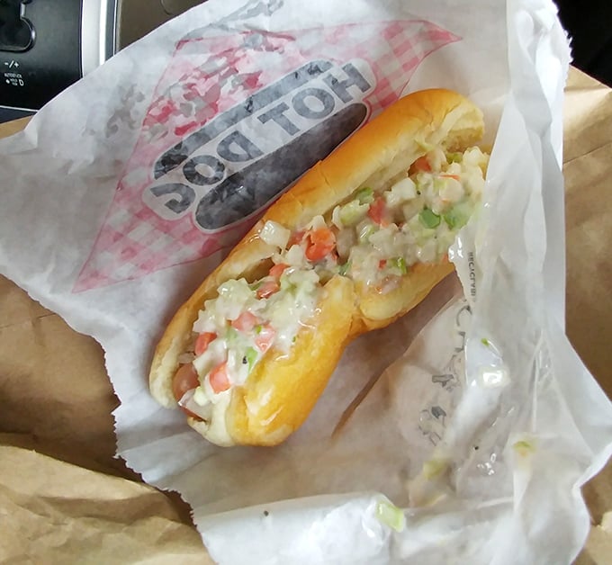The slaw dog—where hot dog meets cool, creamy coleslaw in a summer romance that's lasted decades longer than most.