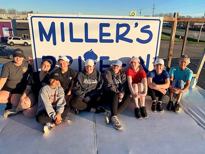 The team behind Miller's poses proudly by their sign—these are the keepers of the flame, the guardians of good taste in small-town America