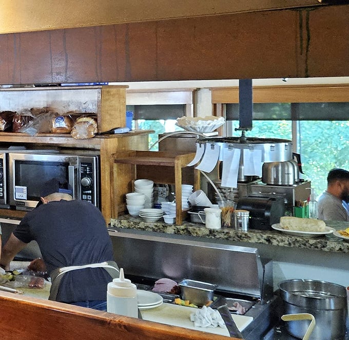 Where breakfast magic happens – the bustling kitchen line where your chicken fried steak dreams are crafted with practiced hands and secret knowledge.