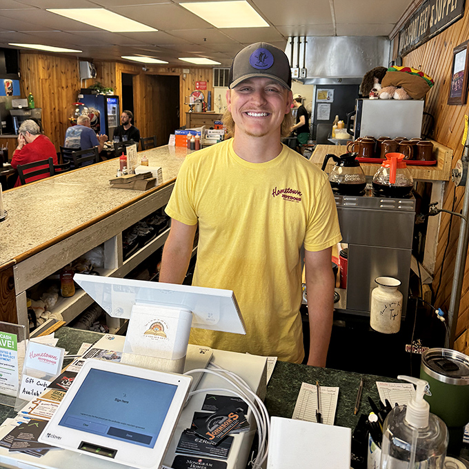 That smile says it all—genuine small-town hospitality served up fresh daily alongside the hot dogs and fries.