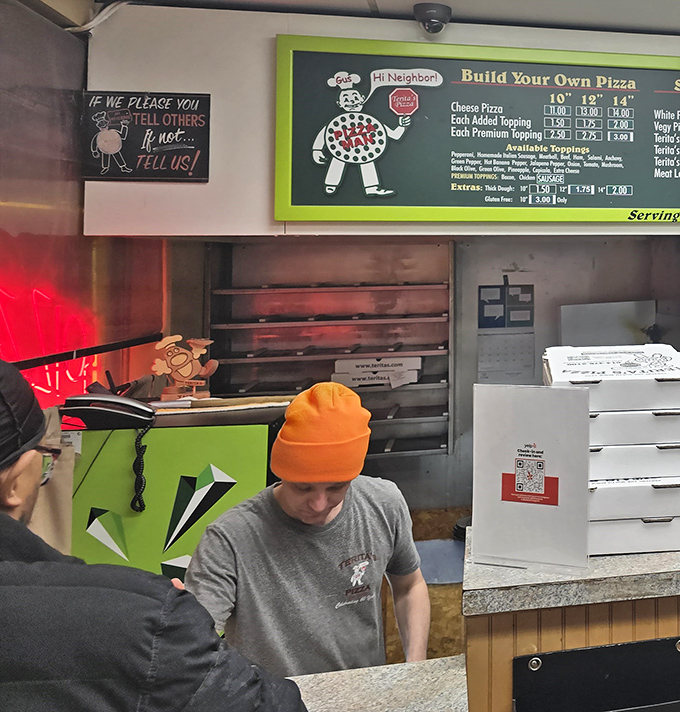 The menu board tells a story of culinary consistency – specialty pizzas that have earned their place through decades of customer loyalty.