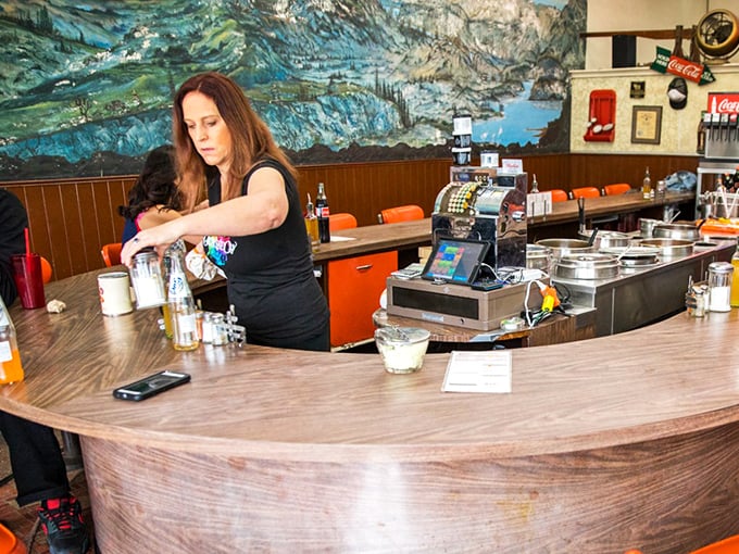 Behind the counter is where the magic happens—no molecular gastronomy, just skilled hands preparing food that tastes like someone cares.