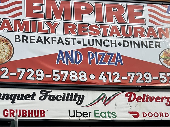 The sign doesn't whisper, it announces: "BREAKFAST • LUNCH • DINNER AND PIZZA"—covering all major food groups in bold, patriotic fashion.