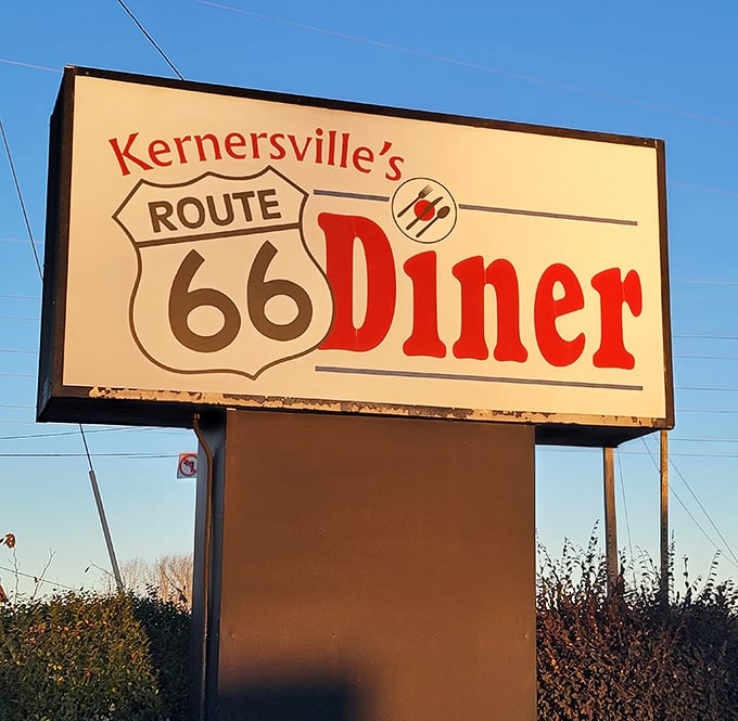 The roadside sign stands tall against Carolina blue skies, a beacon for hungry souls seeking comfort food salvation.