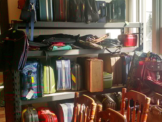 The suitcase collection stands like a museum of travel history—these weathered companions have stories to tell from road trips and family vacations long before rolling luggage.