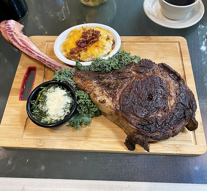 The tomahawk steak arrives like a prehistoric declaration of indulgence—a carnivore's fantasy that makes neighboring tables pause mid-conversation in collective awe.