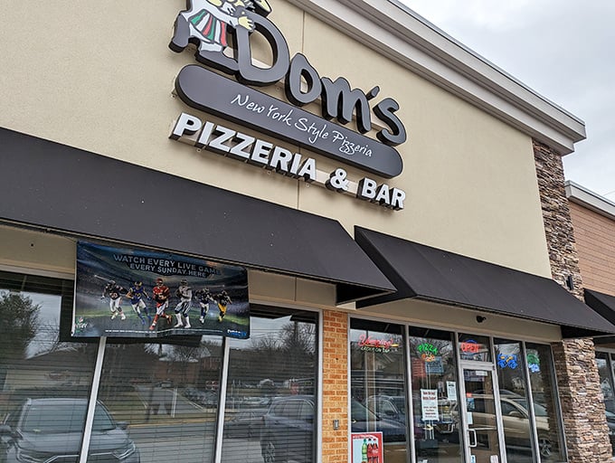 Dom's sleek exterior promises New York pizza attitude in Delaware. That TV isn't the main attraction—what comes out of those ovens is.