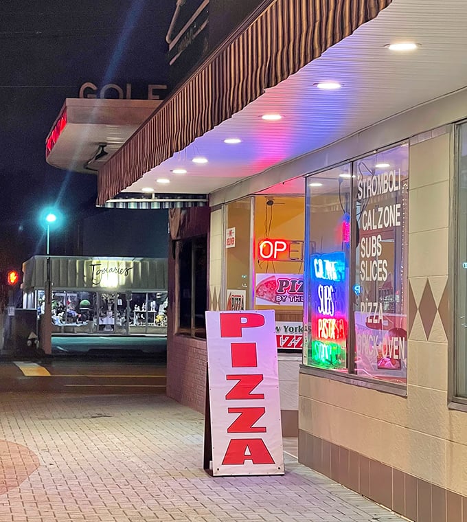 Nighttime reveals the neon glow of pizza perfection. York's storefront may be simple, but those ovens work serious magic.