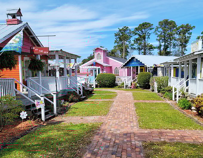 Brightly painted cottages line a charming brick walkway—Southport’s colorful shops create a cheerful, welcoming vibe that’s perfect for strolling and exploring.