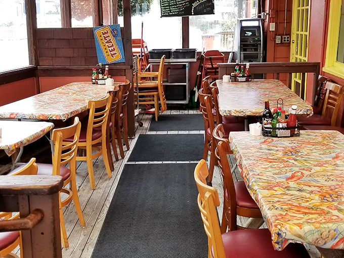Classic wooden tables lined with colorful tablecloths—no white linen pretension here, just the promise of honest seafood and good times.